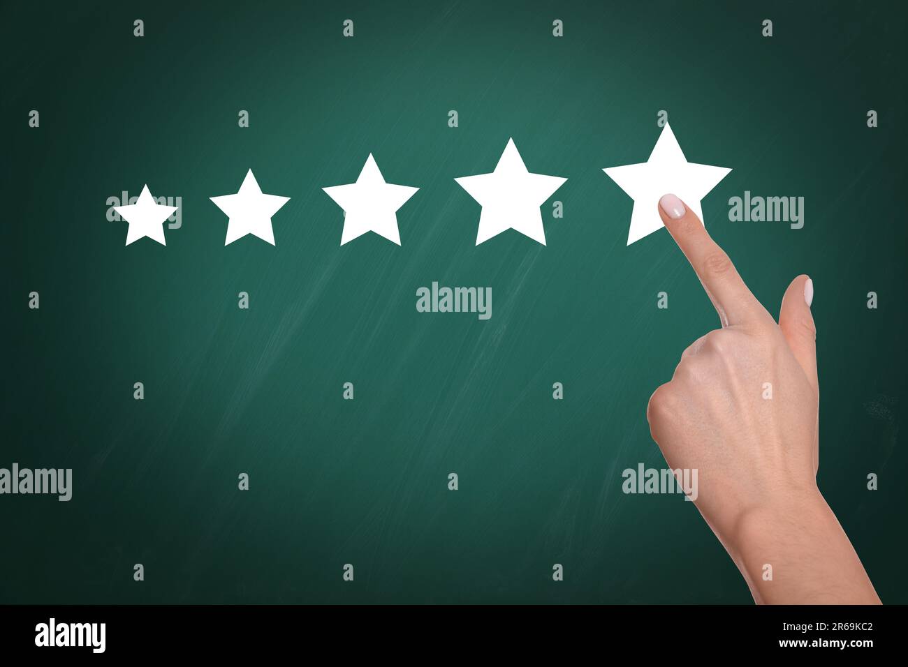 Quality rating. Woman pointing at stars on chalkboard, closeup Stock ...