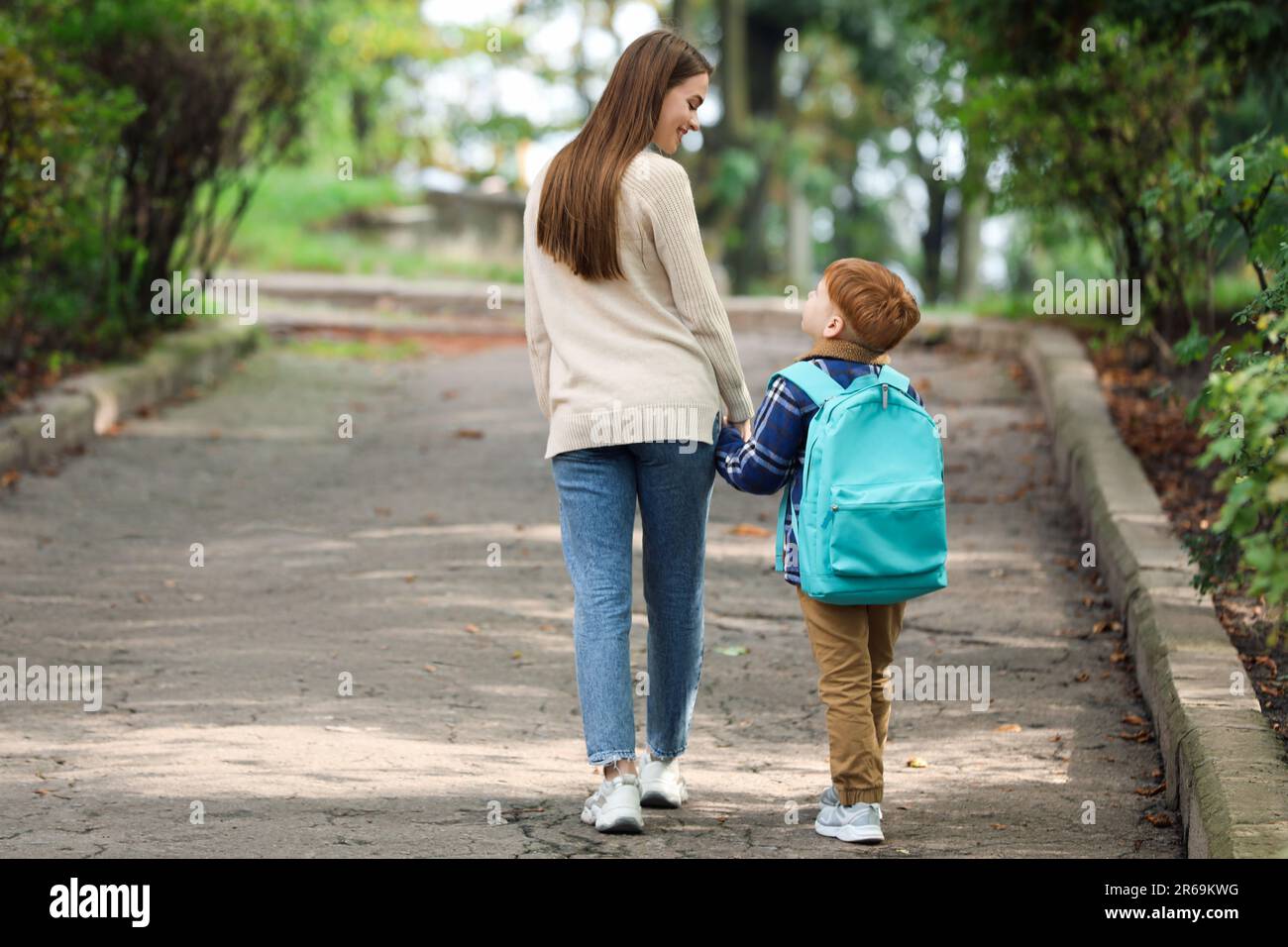 Young mom taking her son to school Stock Photo - Alamy