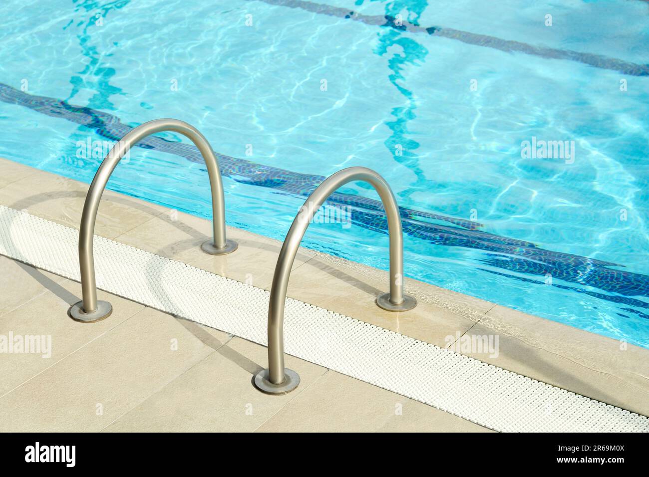 Ladder with handrails in outdoor swimming pool Stock Photo - Alamy