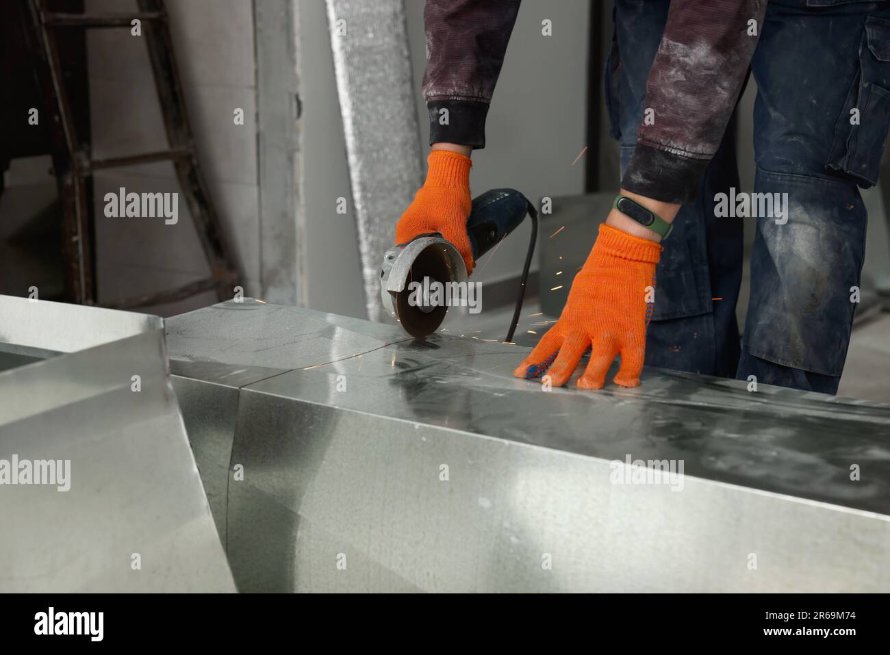 Worker cutting ventilation pipe indoors, closeup view Stock Photo - Alamy