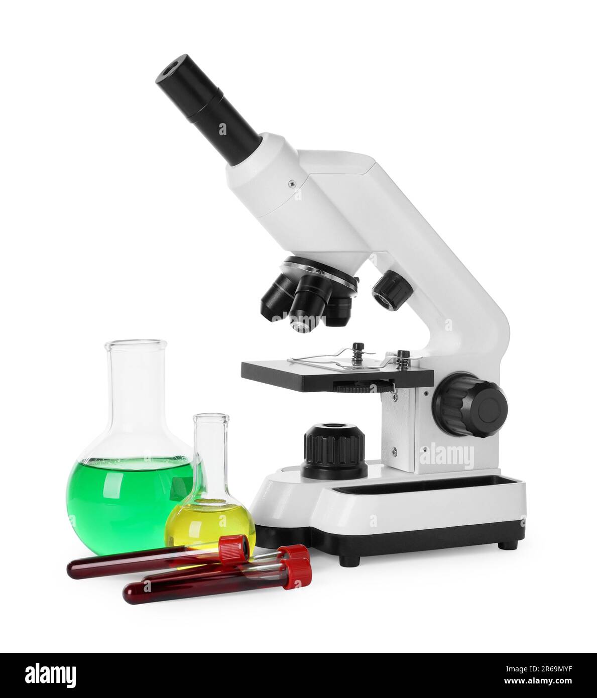 Laboratory glassware with colorful liquids and microscope isolated on ...