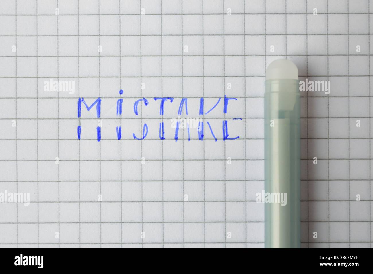 Word Mistake written on checkered paper with erasable pen, top view ...