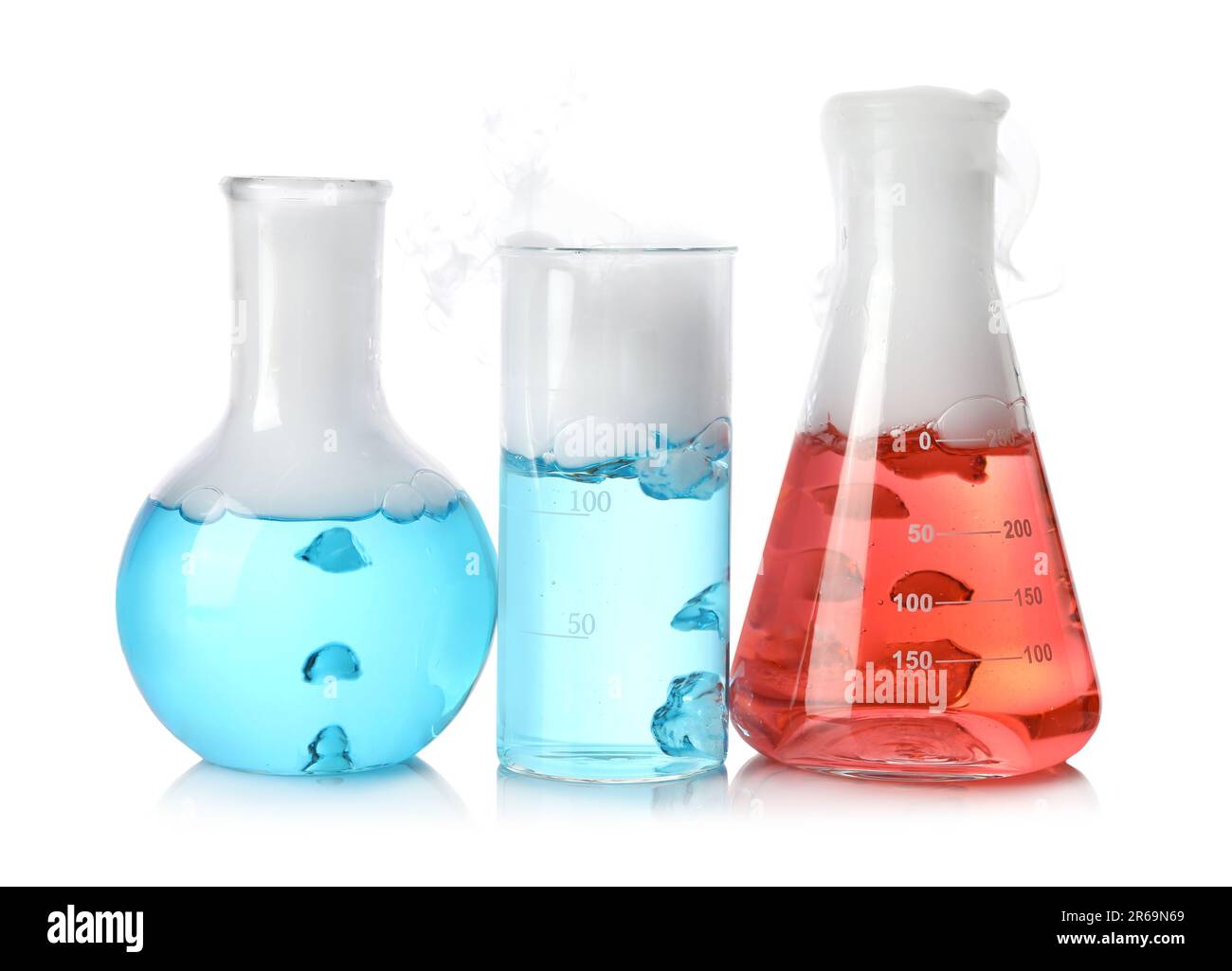 Laboratory glassware with colorful liquids and steam isolated on white ...