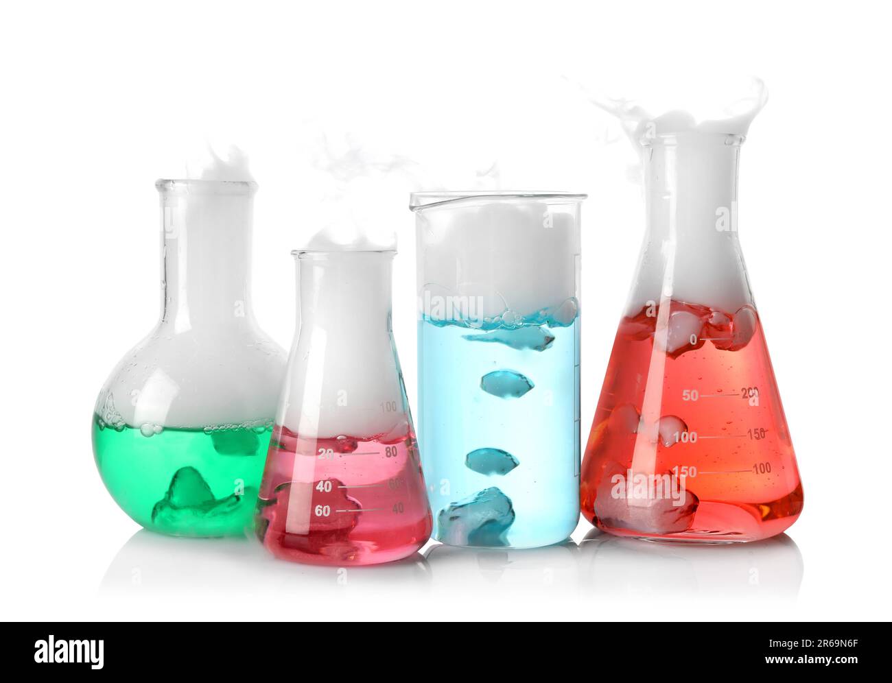 Laboratory glassware with colorful liquids and steam isolated on white ...