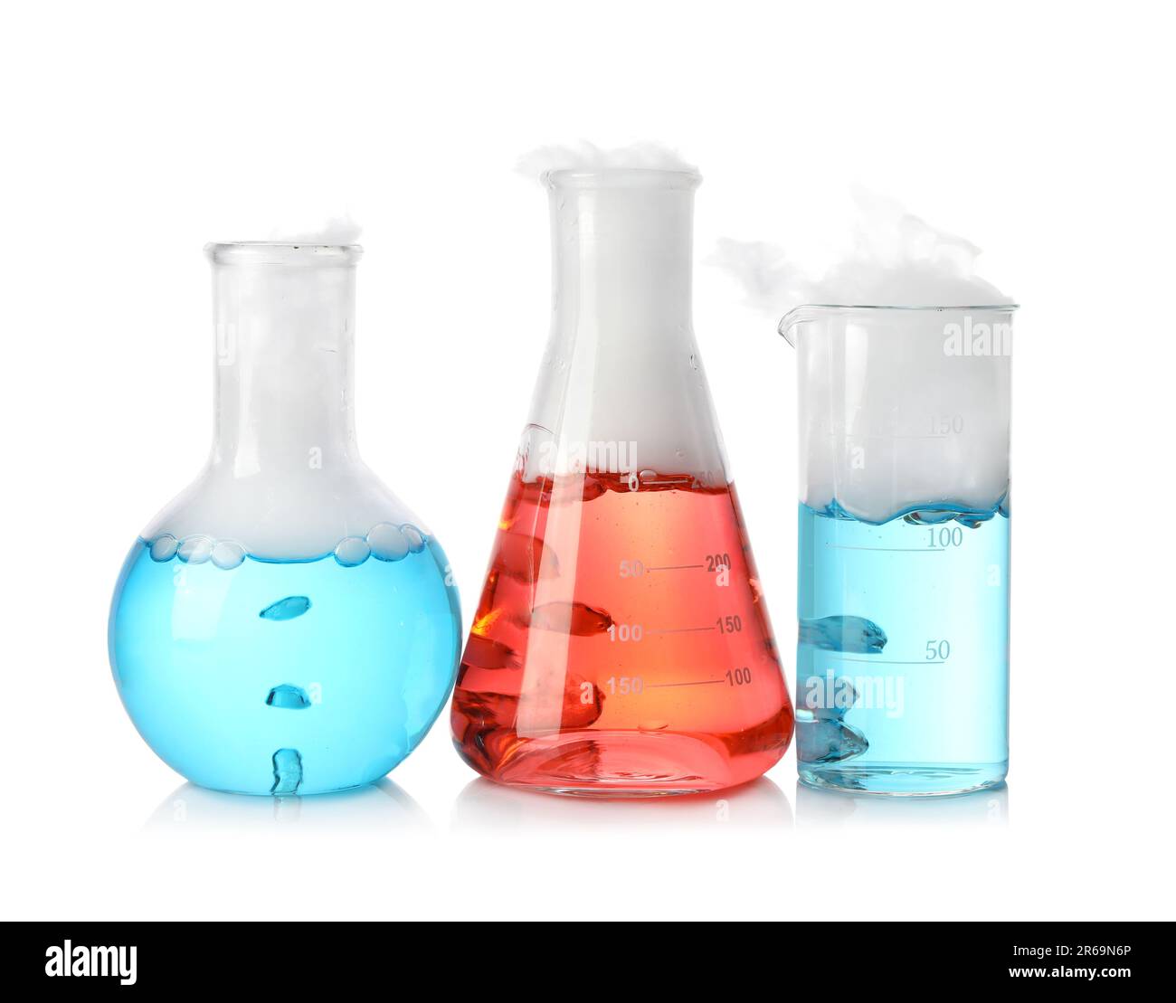 Laboratory glassware with colorful liquids and steam isolated on white ...