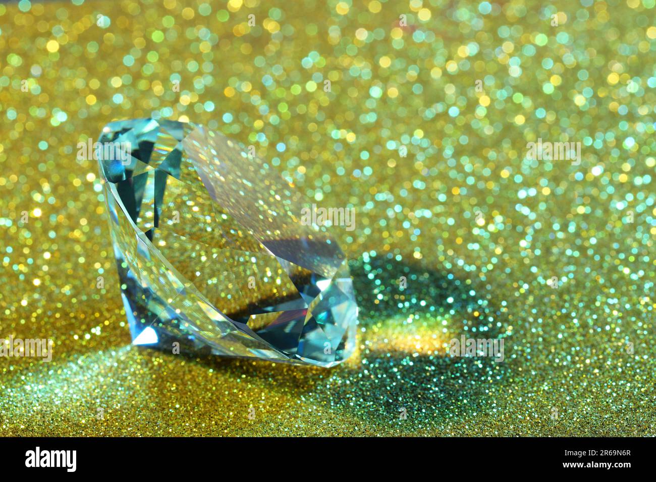 Beautiful dazzling diamond on glitter background, closeup. Space for ...