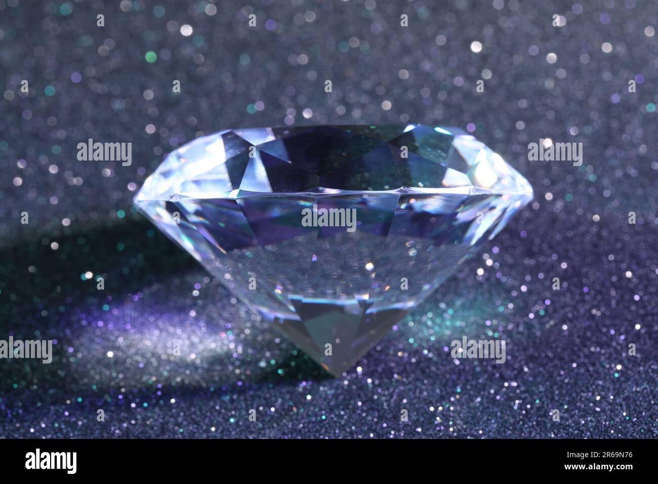 Beautiful dazzling diamond on glitter background, closeup Stock Photo ...