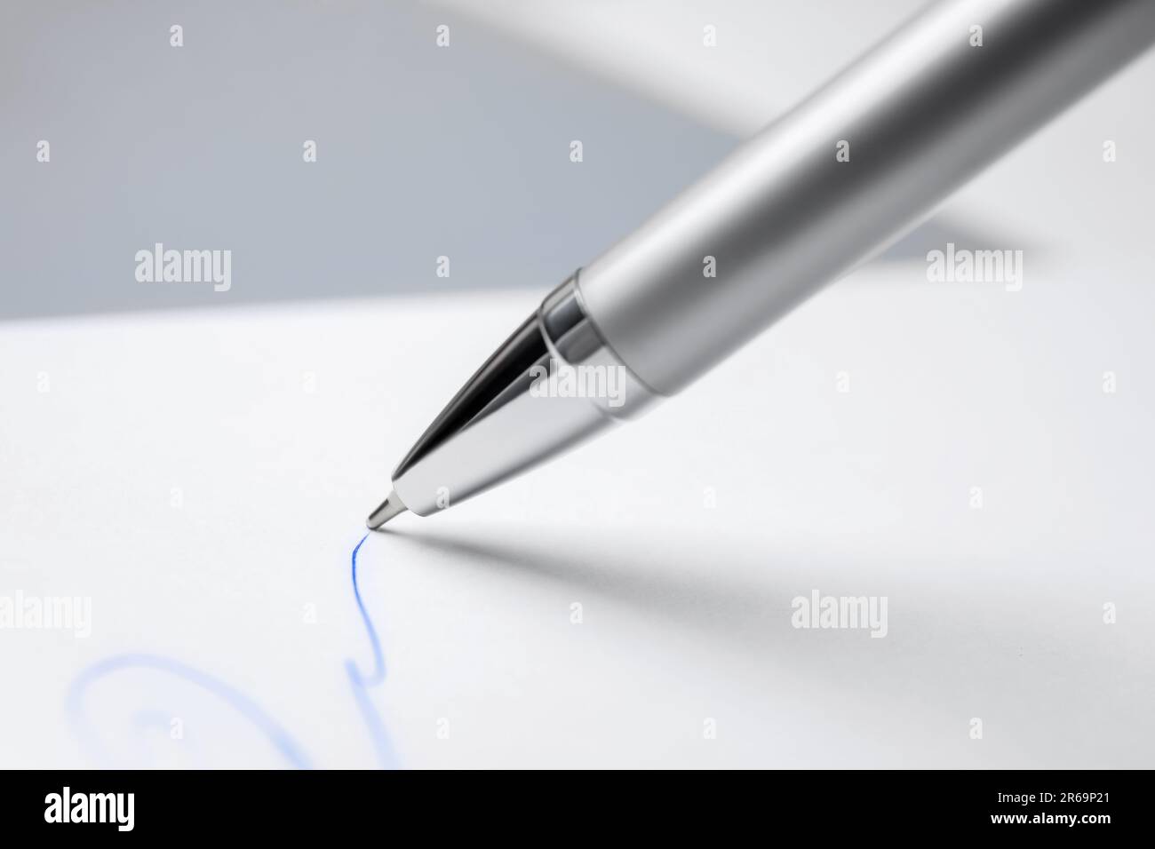 Signing on sheet of white paper with pen, closeup Stock Photo - Alamy