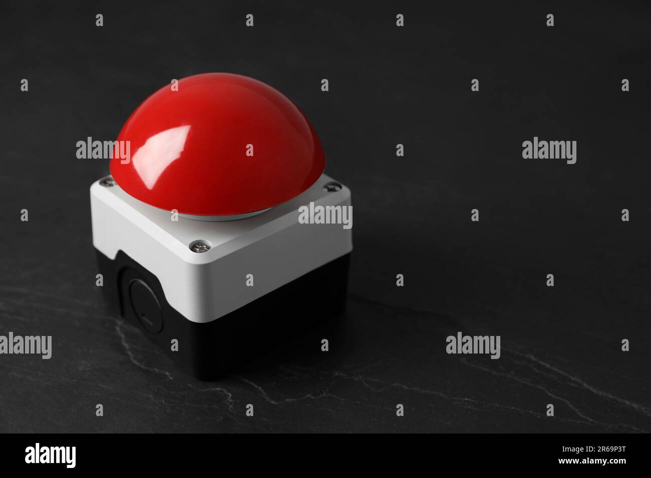 Red button of nuclear weapon on black background, closeup with space ...