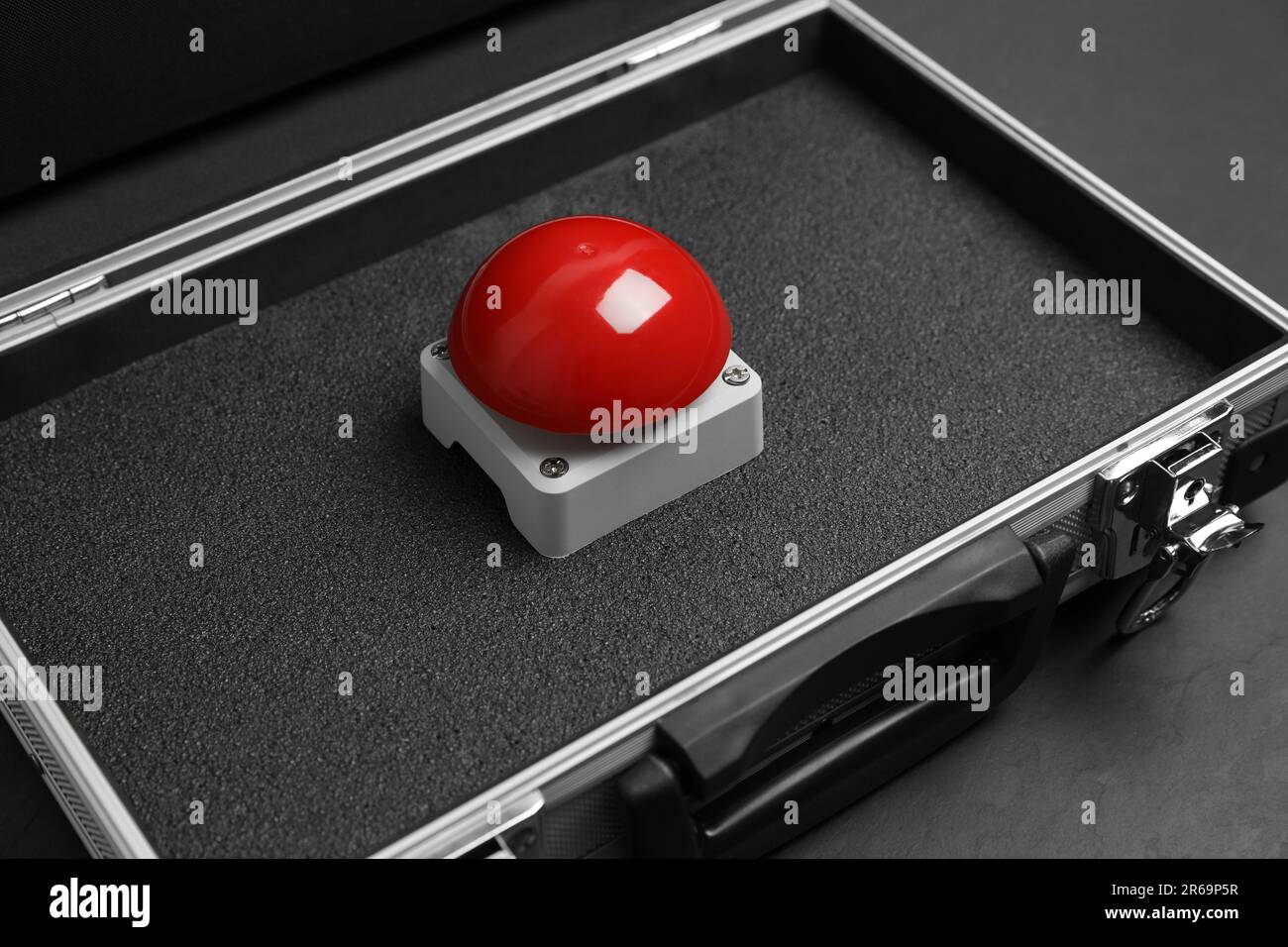 Red button of nuclear weapon in suitcase on black background. War ...