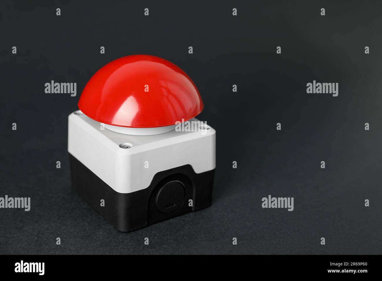 Red button of nuclear weapon on black background, closeup with space ...