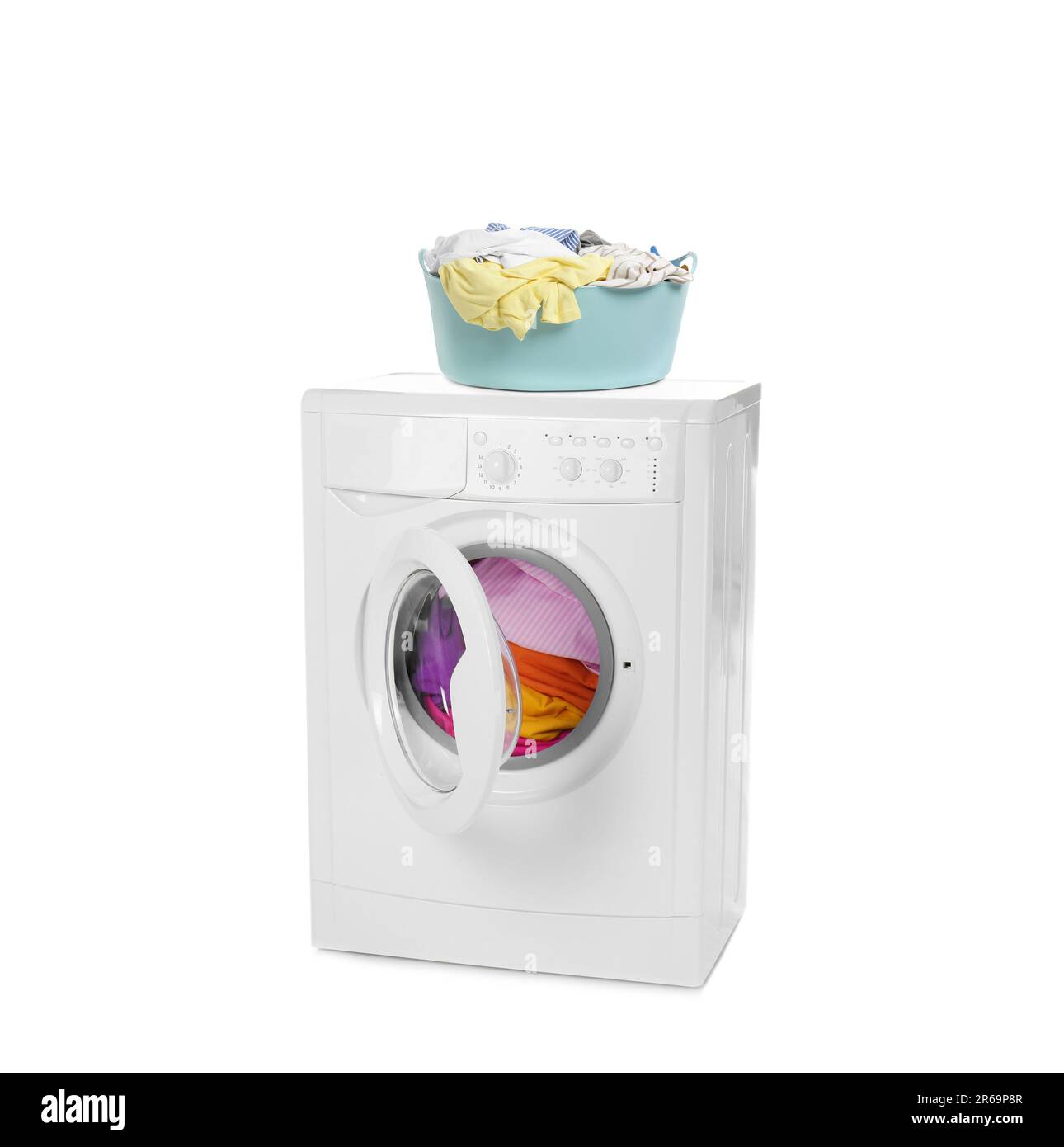 Washing machine and plastic laundry basket full of clothes on white ...