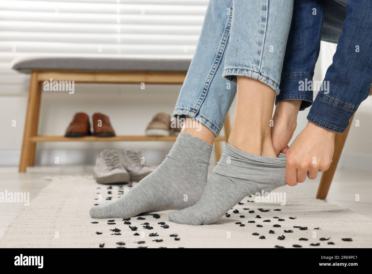 Woman putting on socks hi-res stock photography and images - Alamy