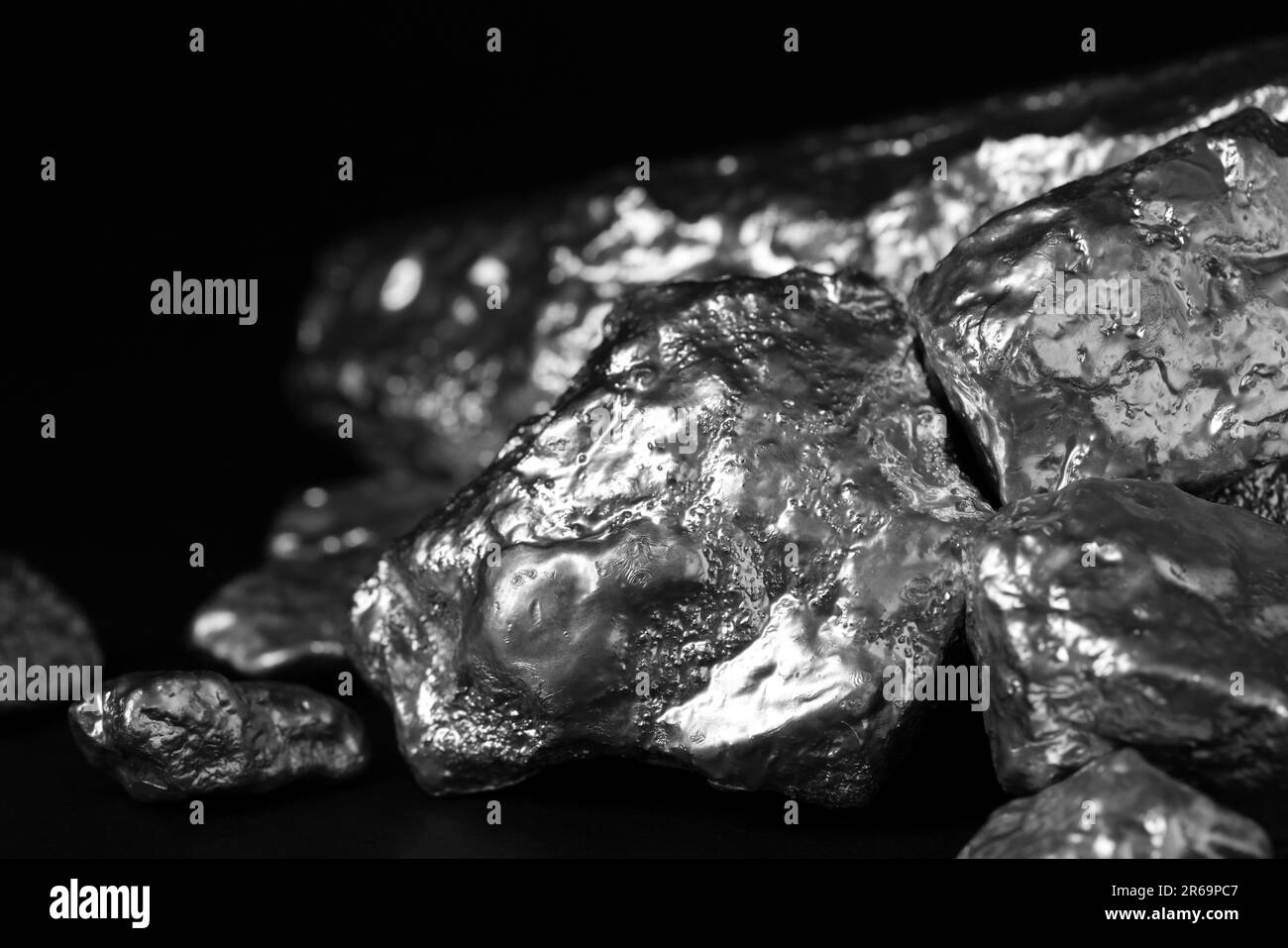 Pile of silver nuggets on black background, closeup Stock Photo - Alamy