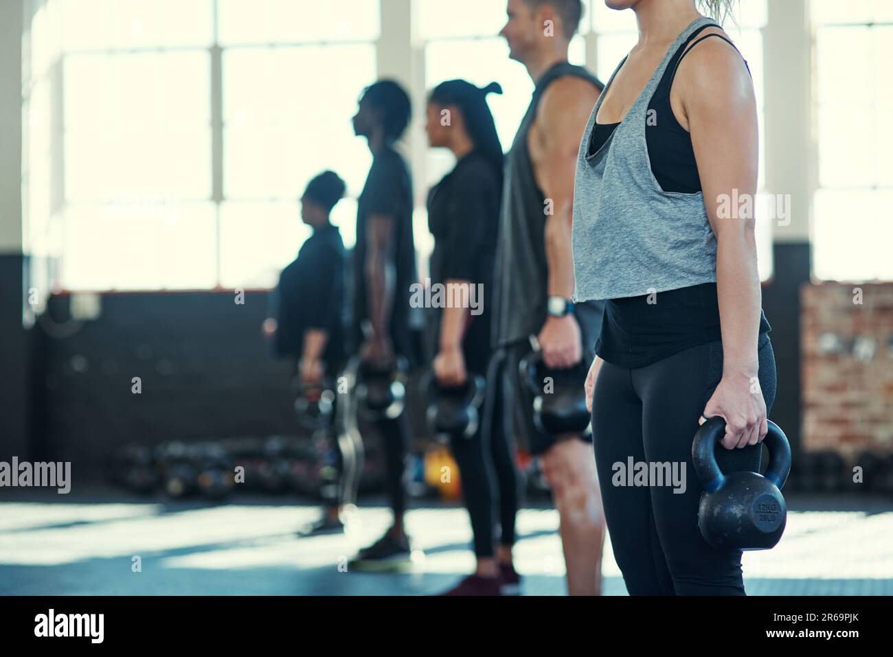Follow my lead. a focused group of young people standing in a row and ...