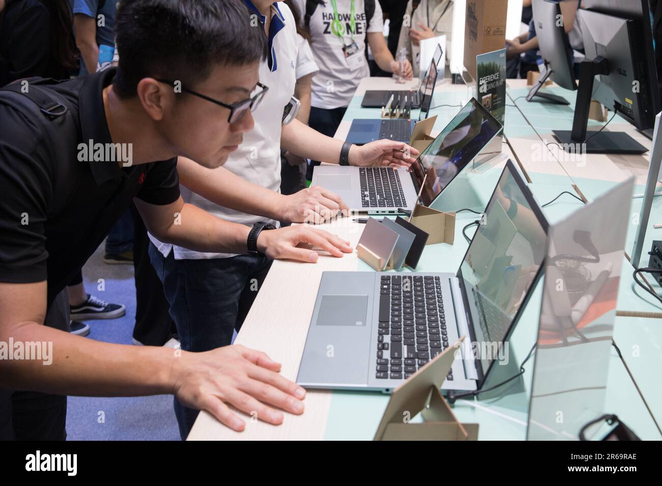 Visitors try Asus notebook at Computex ,a computer and technology trade ...