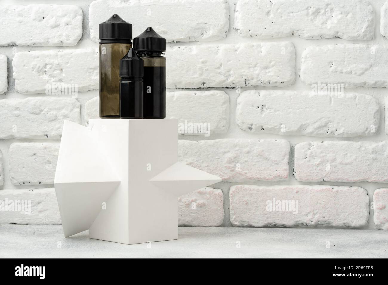 Refill liquid for electronic cigarettes against brick wall background ...