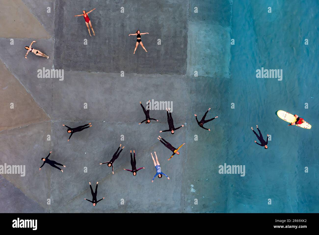 People float above patterns seen on the concrete base of the pool at ...