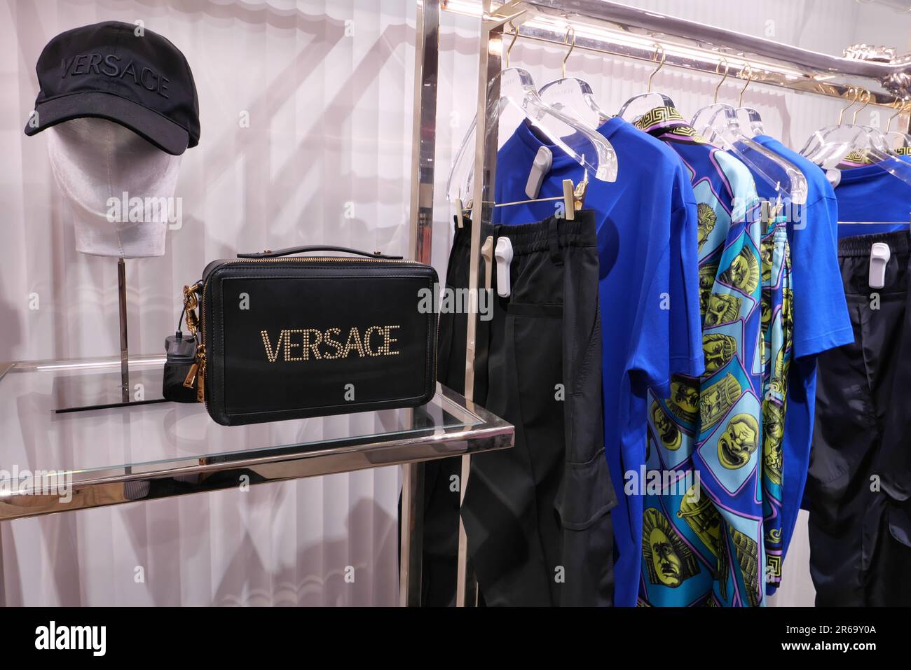 VERSACE HAT,BAG AND CLOTHING ON DISPLAY INSIDE THE FASHION STORE Stock ...