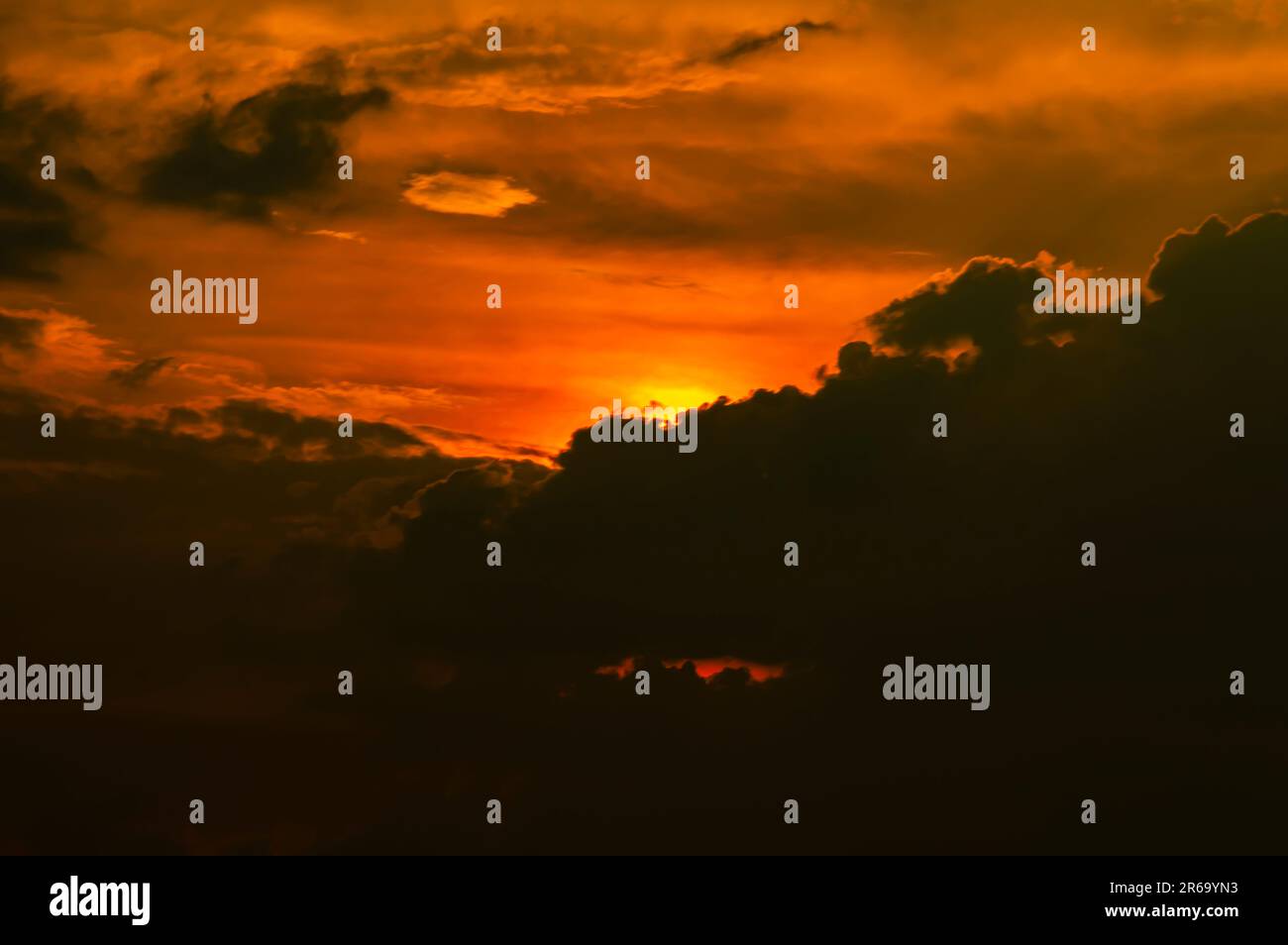 Evening sunrise in the storm clouds of a dramatic sky. The sun behind a ...