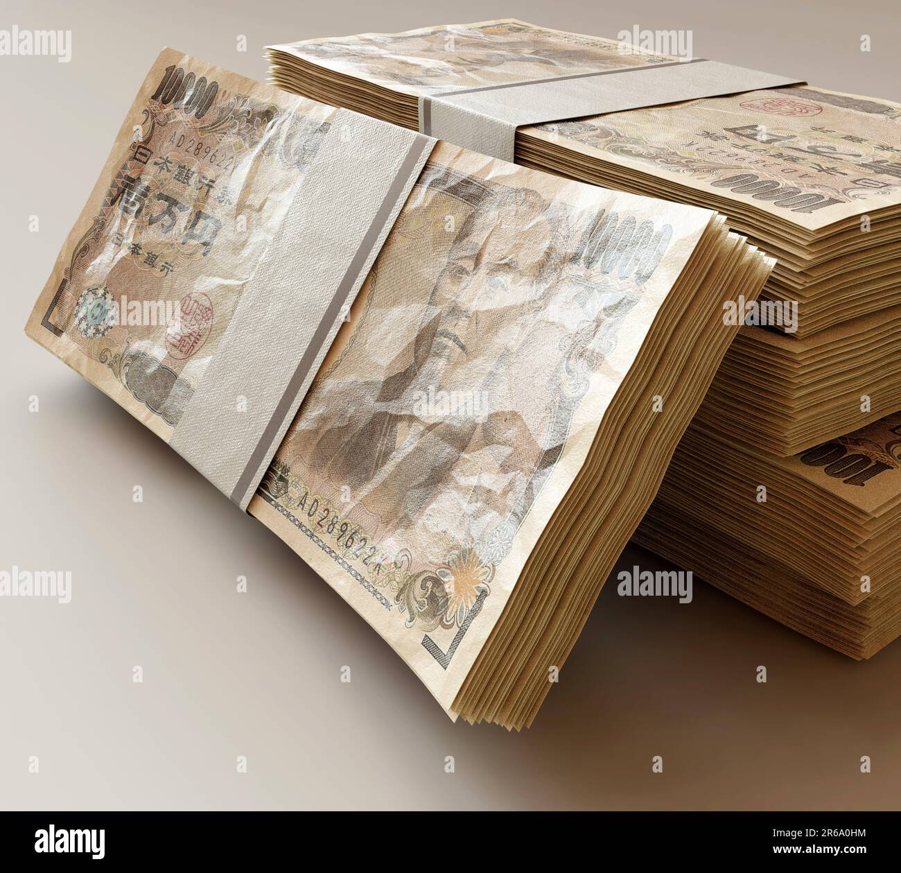 A stack of bundled japanese yen banknotes on an isolated light ...