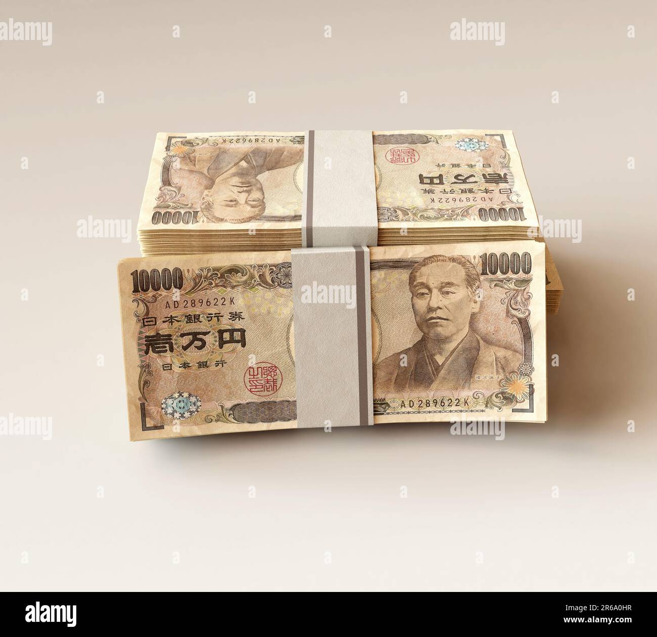 A stack of bundled japanese yen banknotes on an isolated light ...
