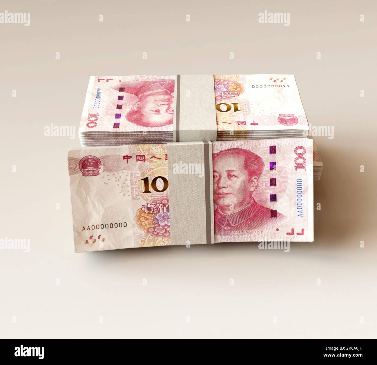 A stack of bundled chinese yuan banknotes on an isolated light ...