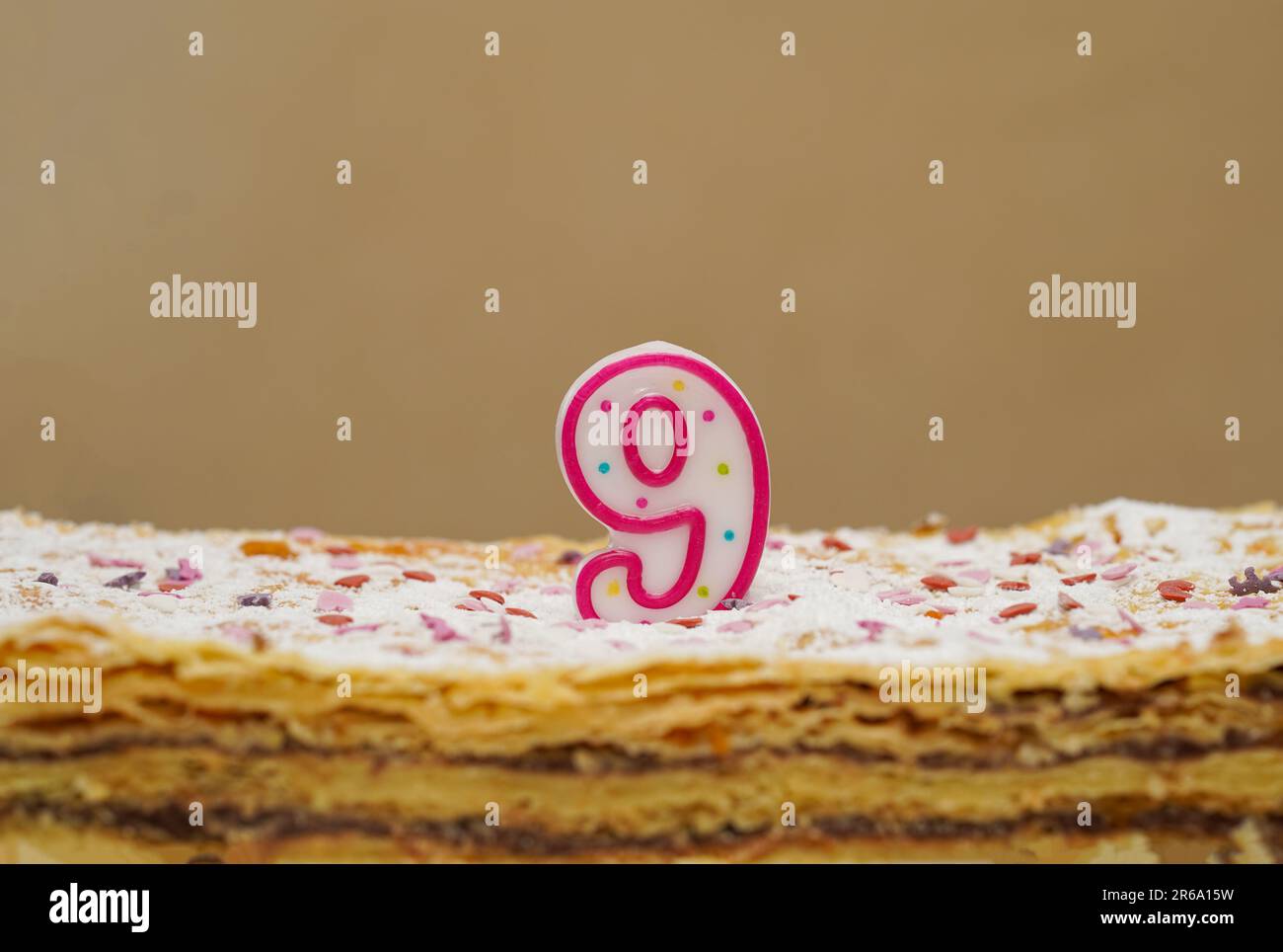 Birthday layer cake with candle number 9 nine close-up. Birthday cake ...