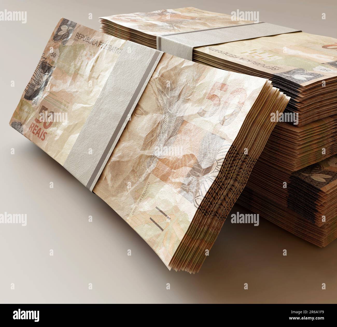 A stack of bundled brazilian real banknotes on an isolated light ...