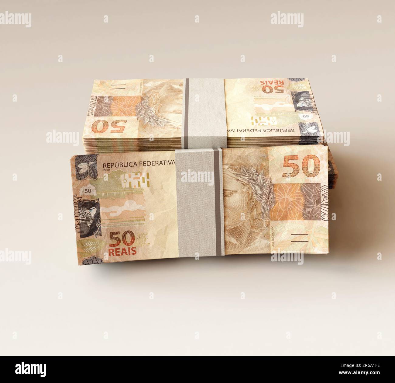 A stack of bundled brazilian real banknotes on an isolated light ...