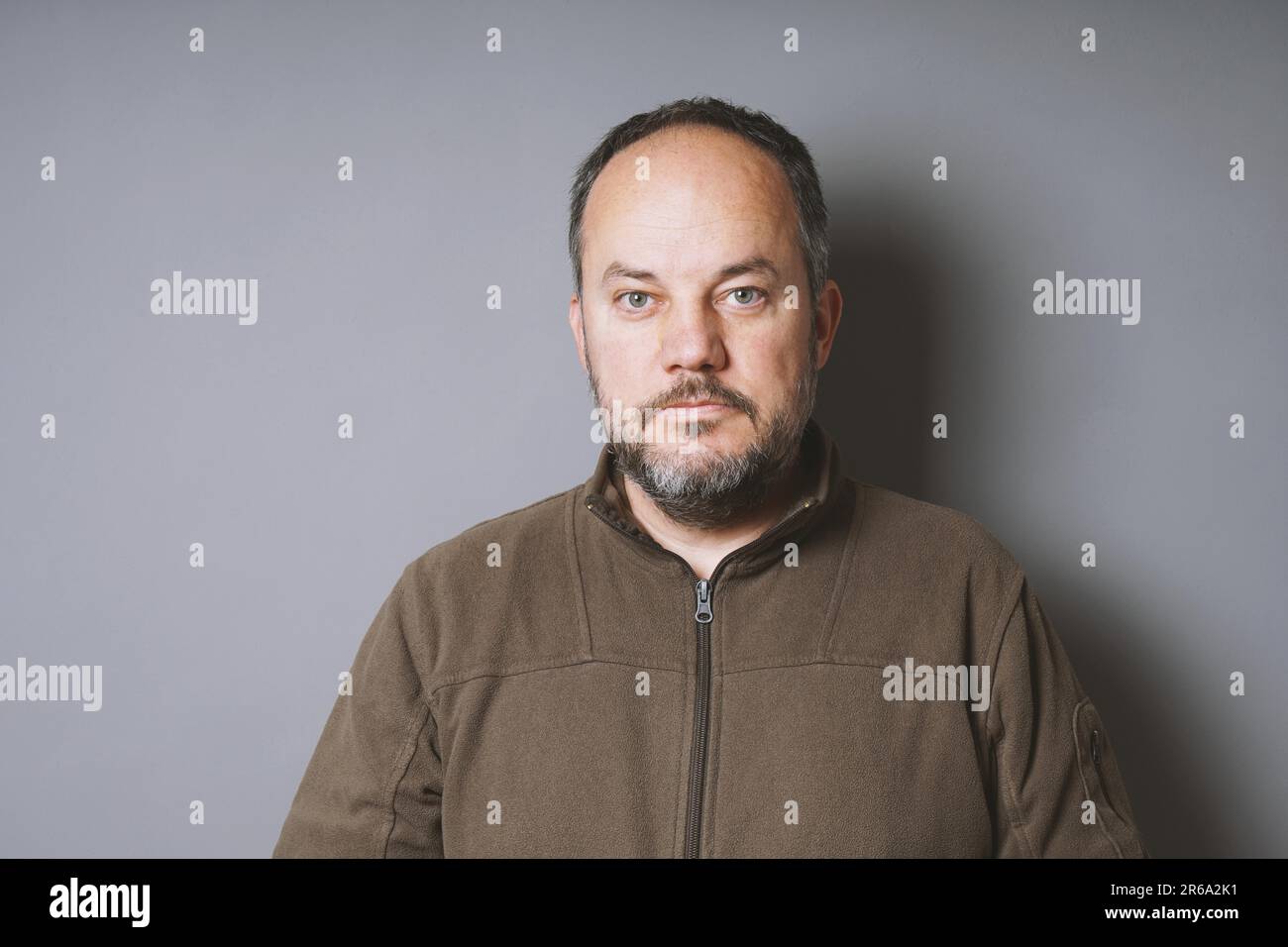 middle aged man in his 40s with short dark hair and graying beard ...