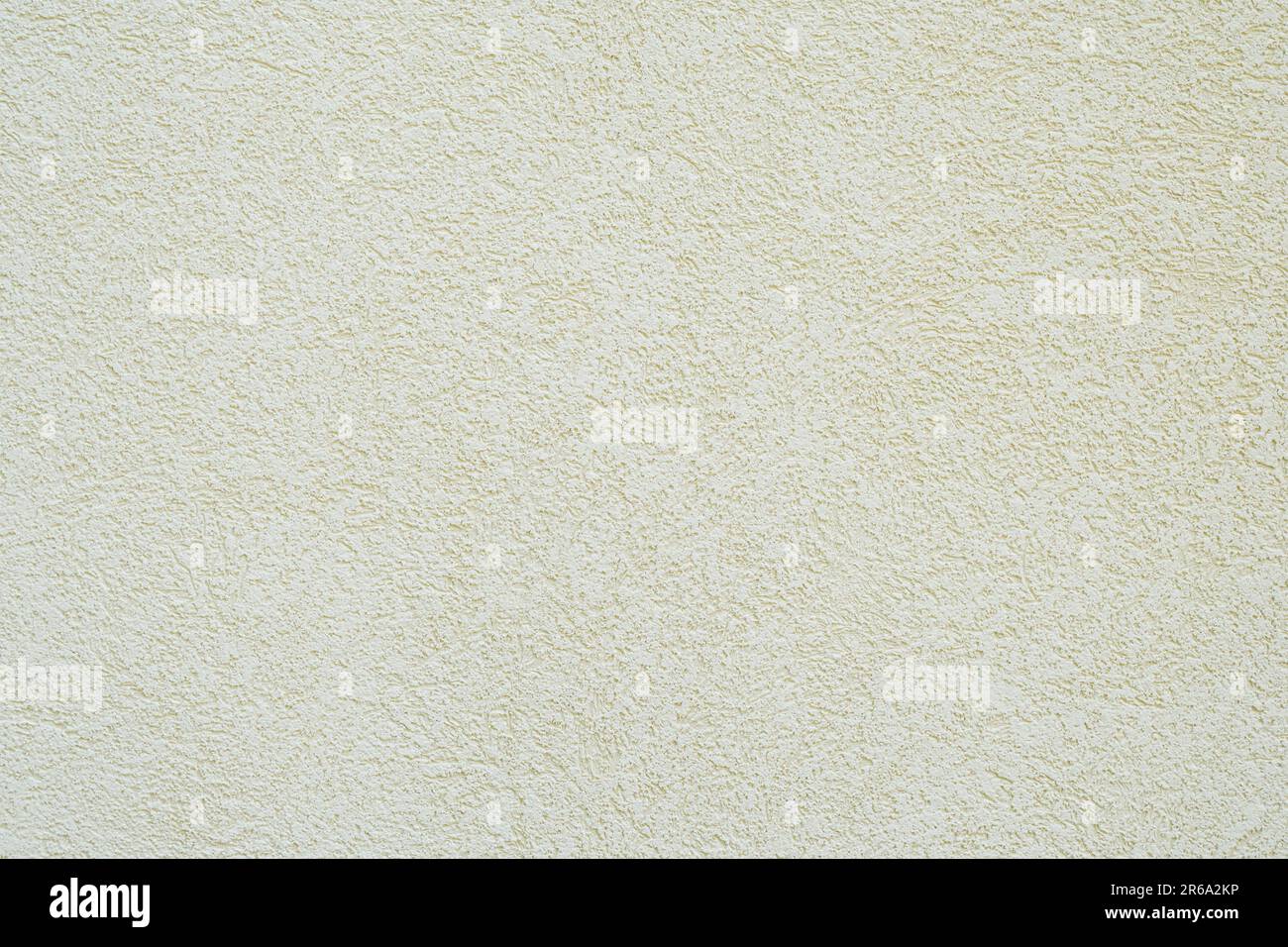 background wall with off-white or pale yellow roughcast plaster texture ...