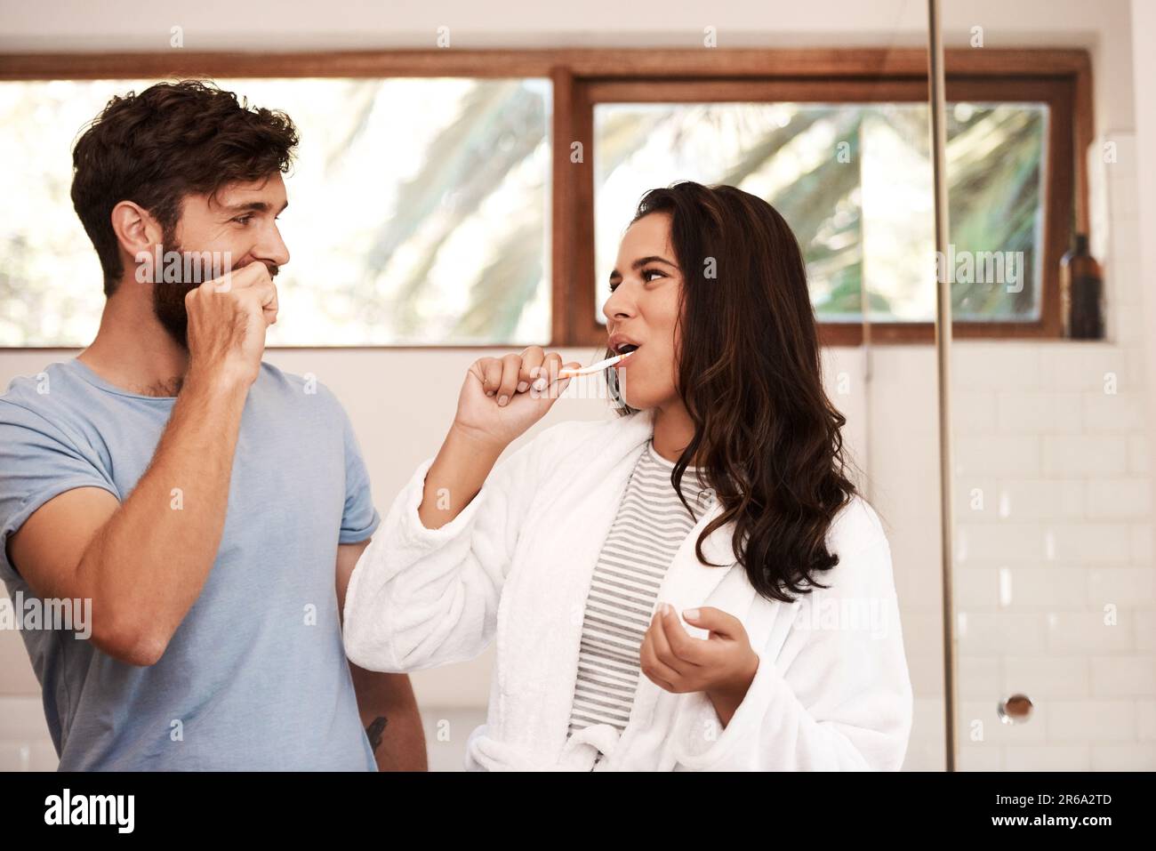 Dental, home bathroom and happy couple brushing teeth with toothbrush ...