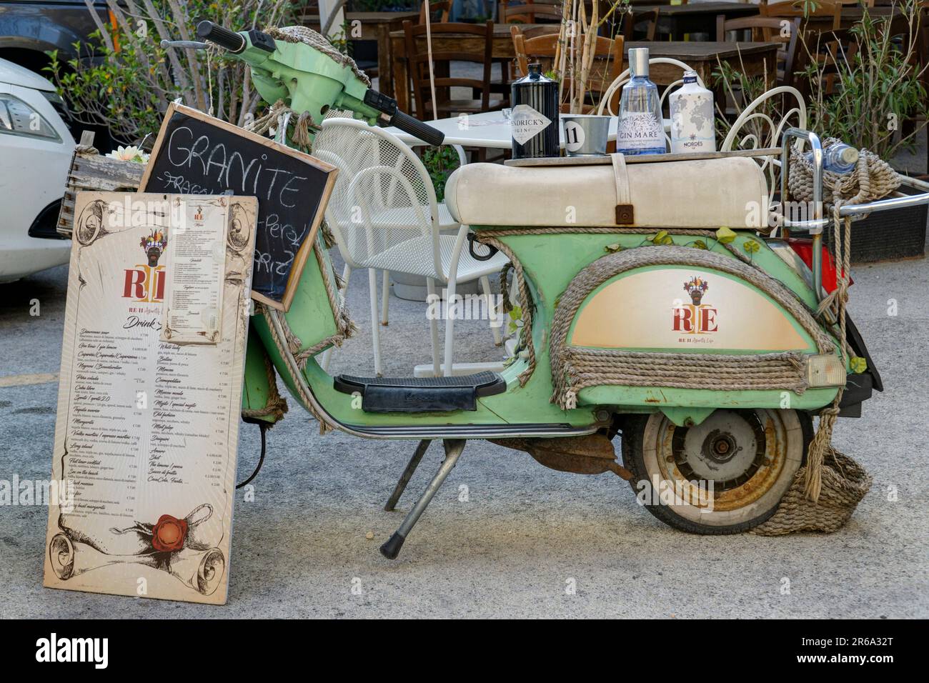 Restaurant menu propped up against Vespa scooter in street on ortigia ...