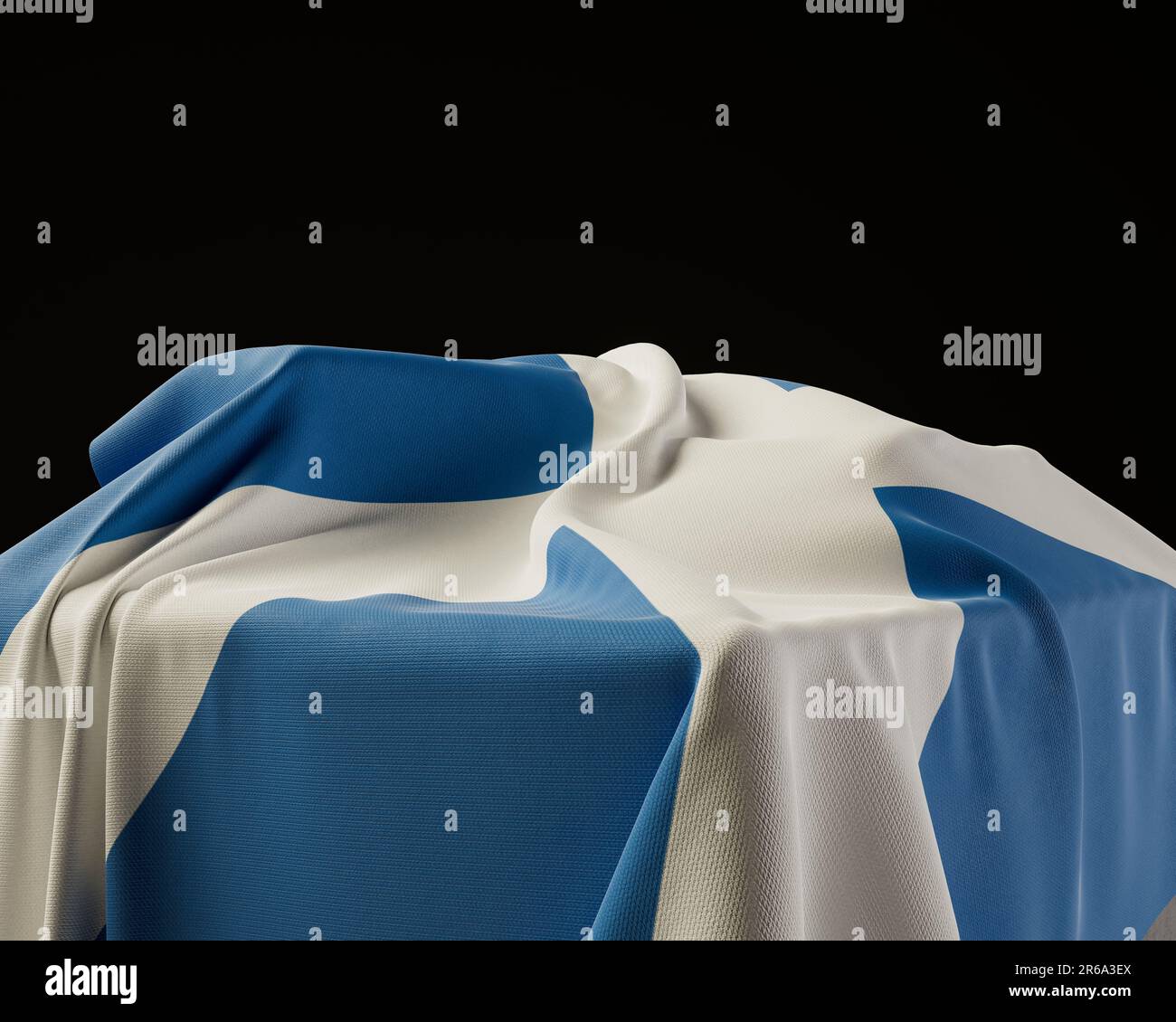 A scotland flag draped over a stone plinth on an isolated dark studio ...