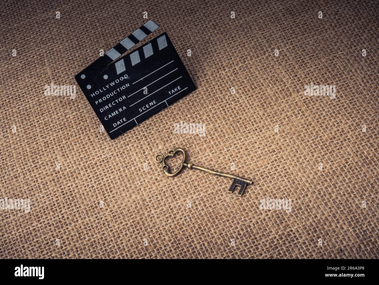 Movie clapper and retro key on canvas background Stock Photo - Alamy