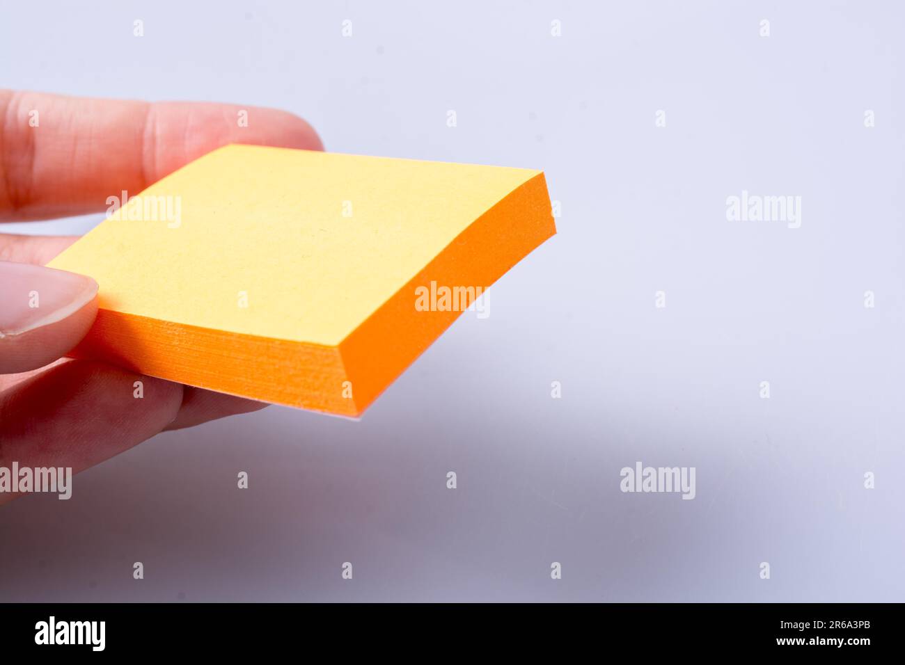 Post note office sticker for taking notes in hand Stock Photo - Alamy