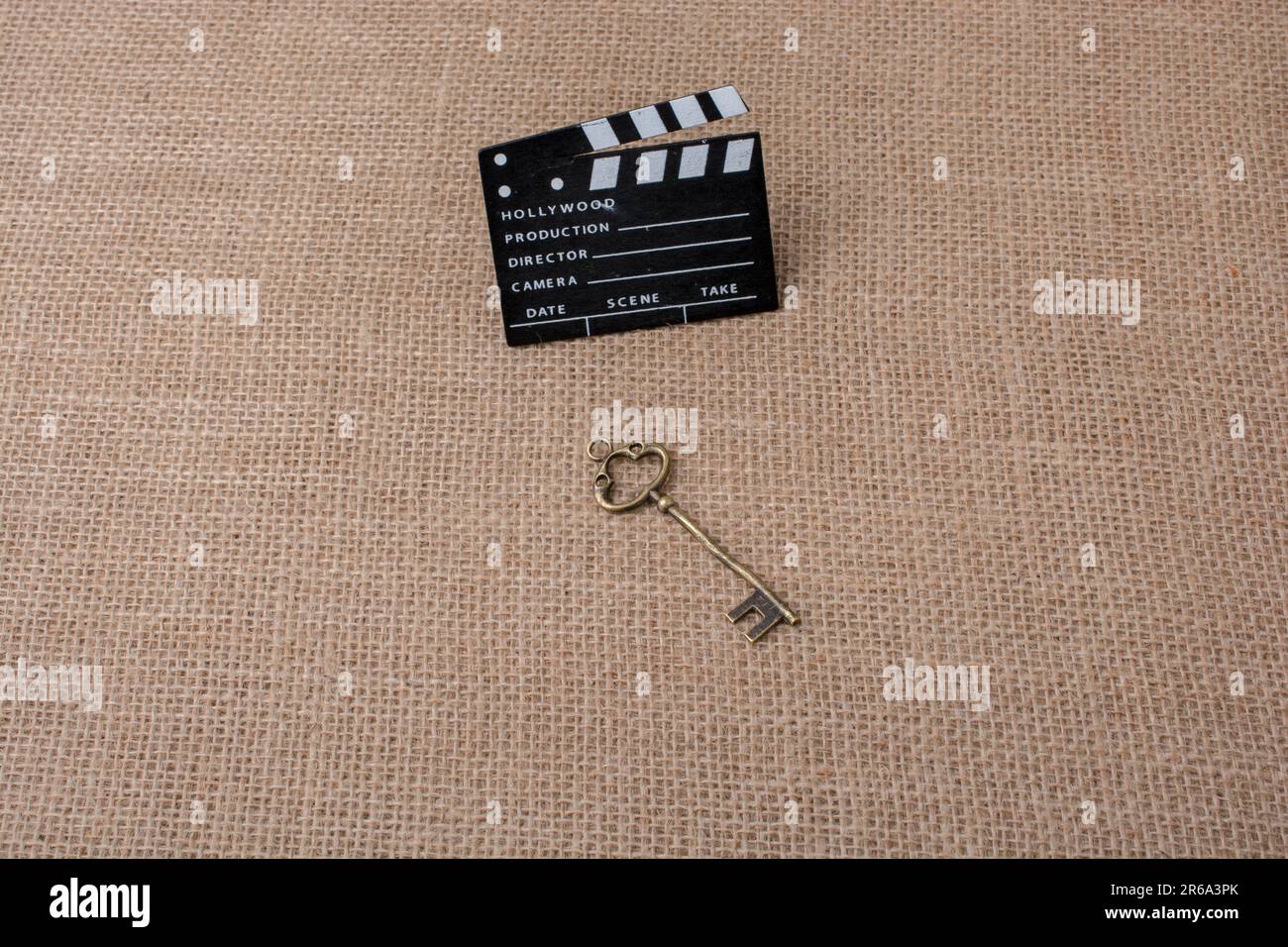 Movie clapper and retro key on canvas background Stock Photo - Alamy