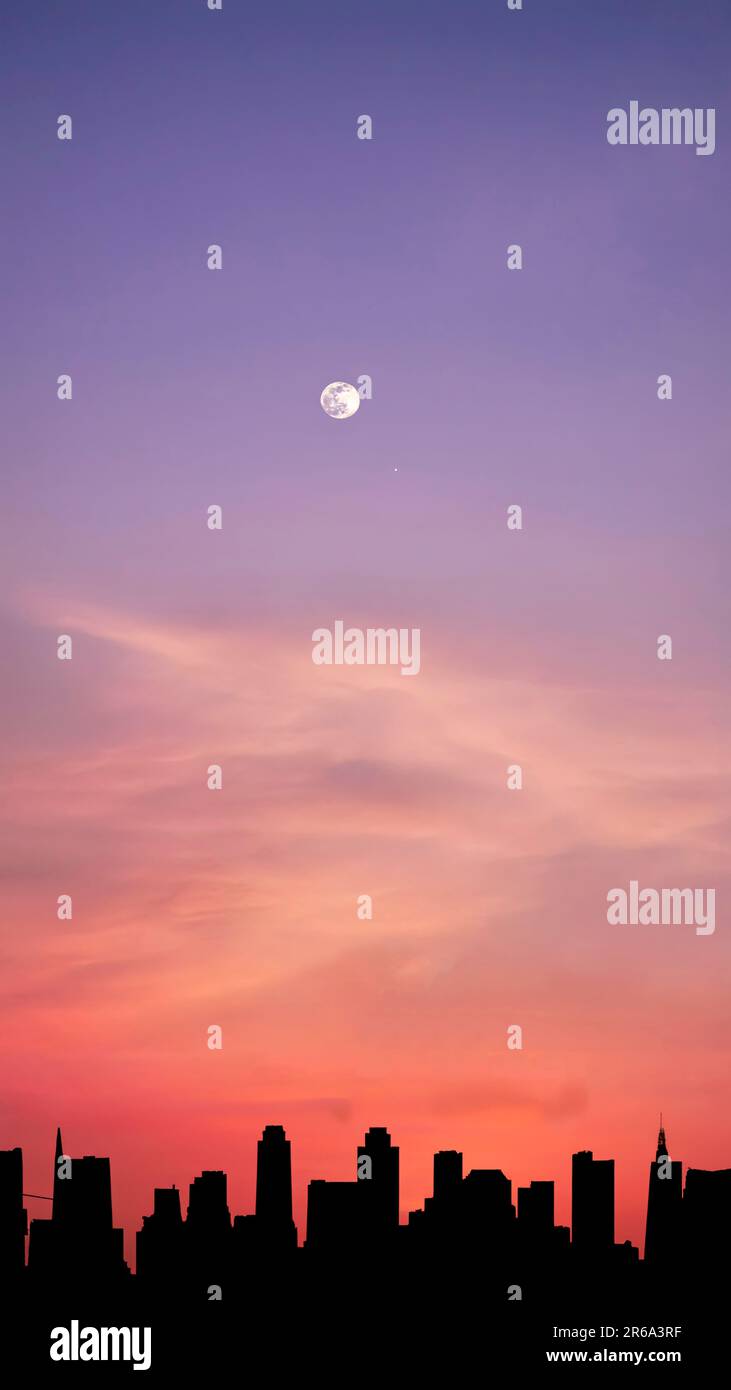 Vertical image, full moon in dramatic vibrant color clouds and sky with ...