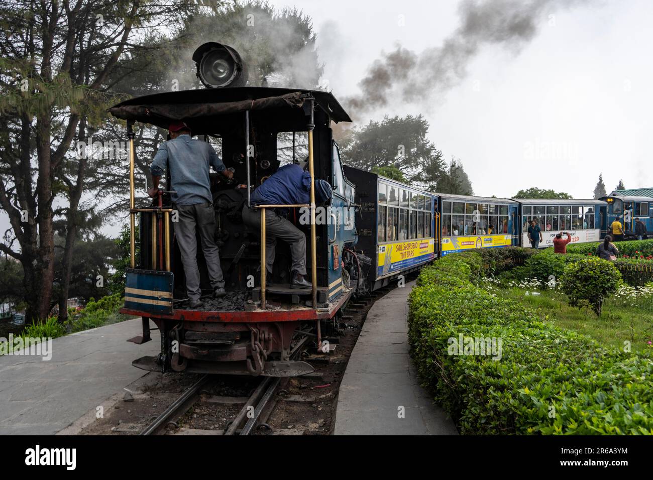 DARJEELING, INDIA, MAY 25: Tourists travel in a steam loco engined toy ...