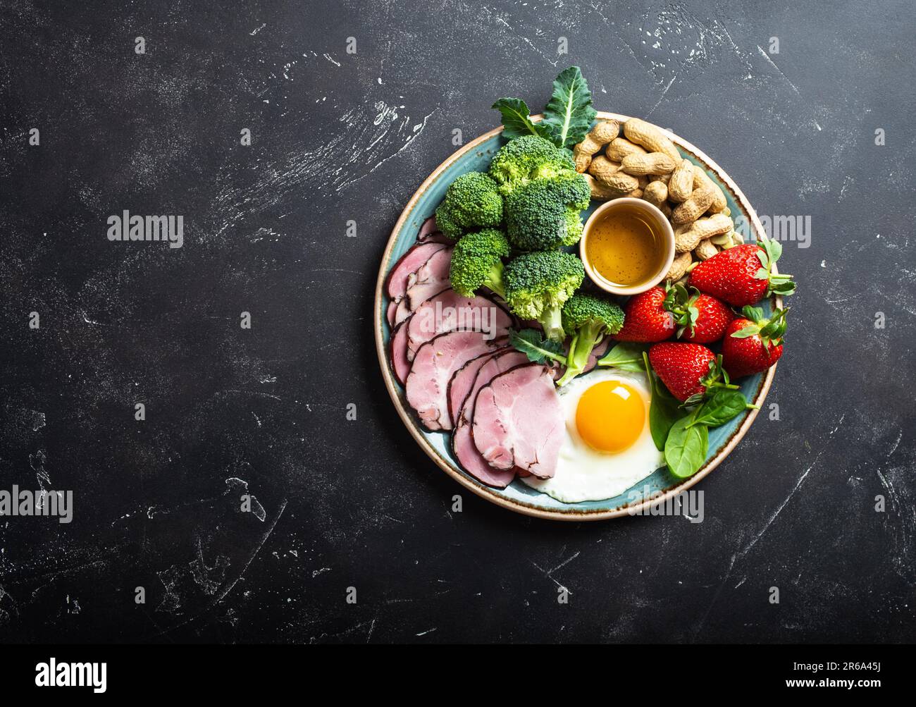 Ketogenic low carbs diet, top view, space for text. Plate on stone ...