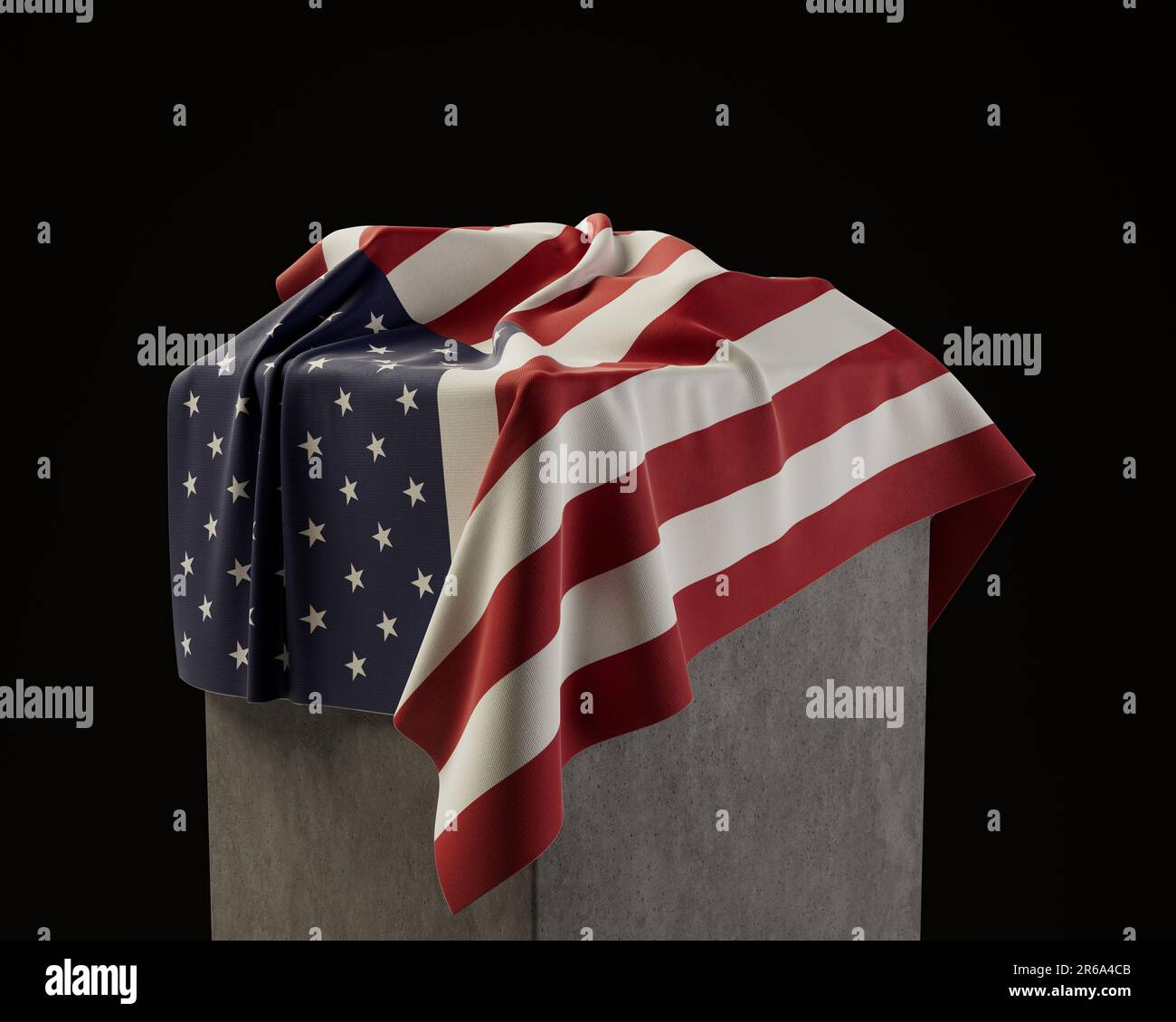 An american flag draped over a stone plinth on an isolated dark studio ...