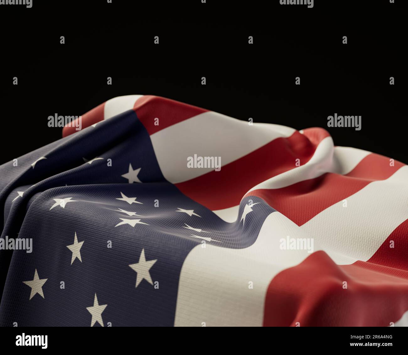 An american flag draped over a stone plinth on an isolated dark studio ...