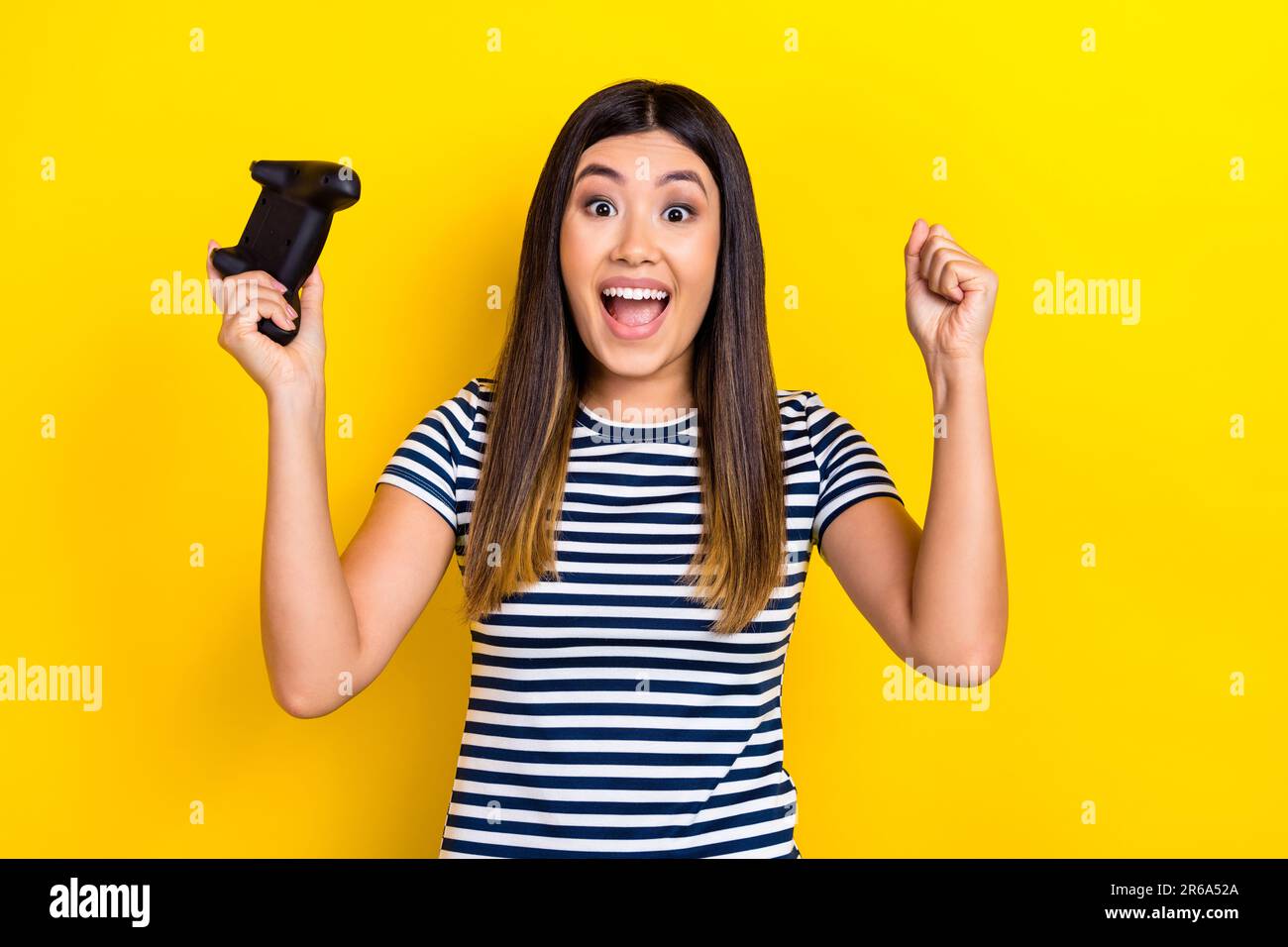 Portrait Photo Of Young Crazy Overjoyed Japanese Woman Fist Up Playing Gamepad Joystick