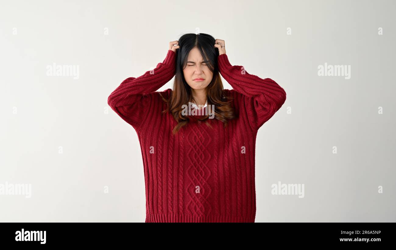 A pretty young Asian woman in a red sweater, feeling confused and ...