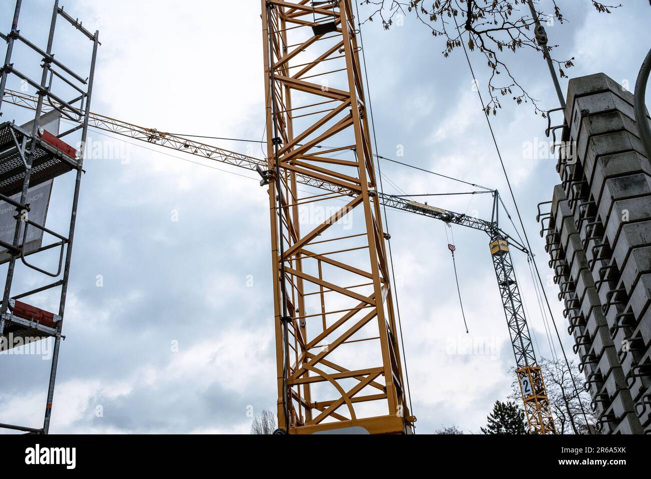 An aerial view of a crane standing in a construction site among other ...