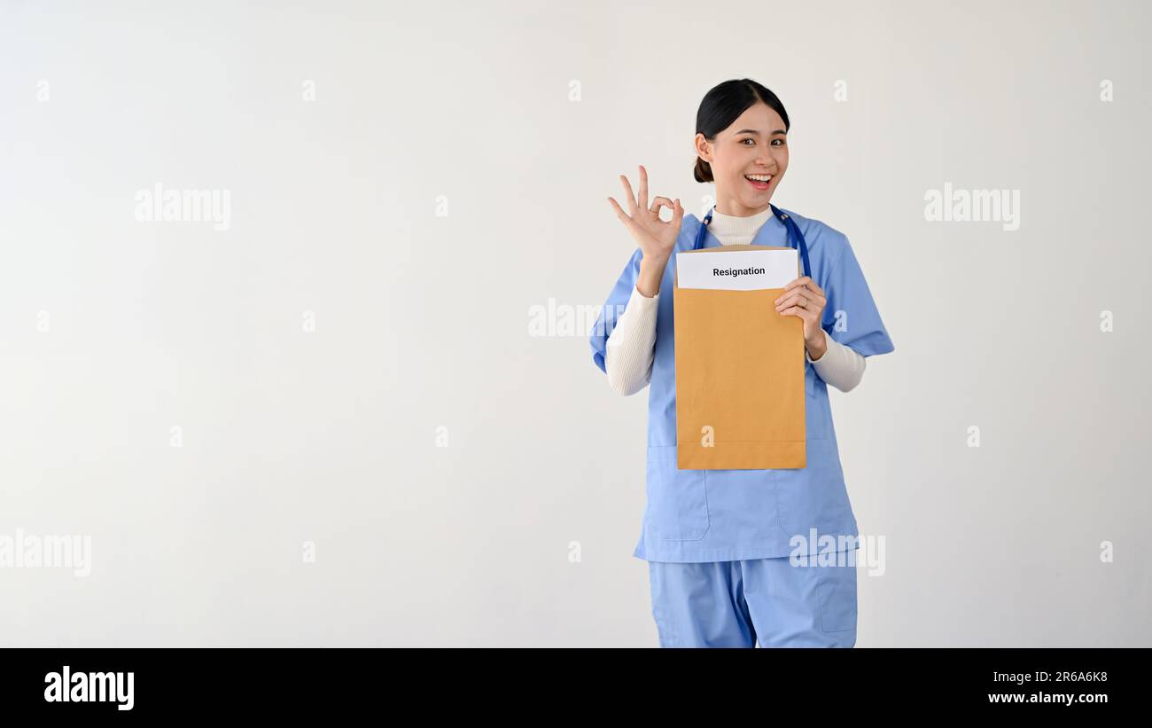 A cheerful Asian female doctor or medical worker holding a resignation ...