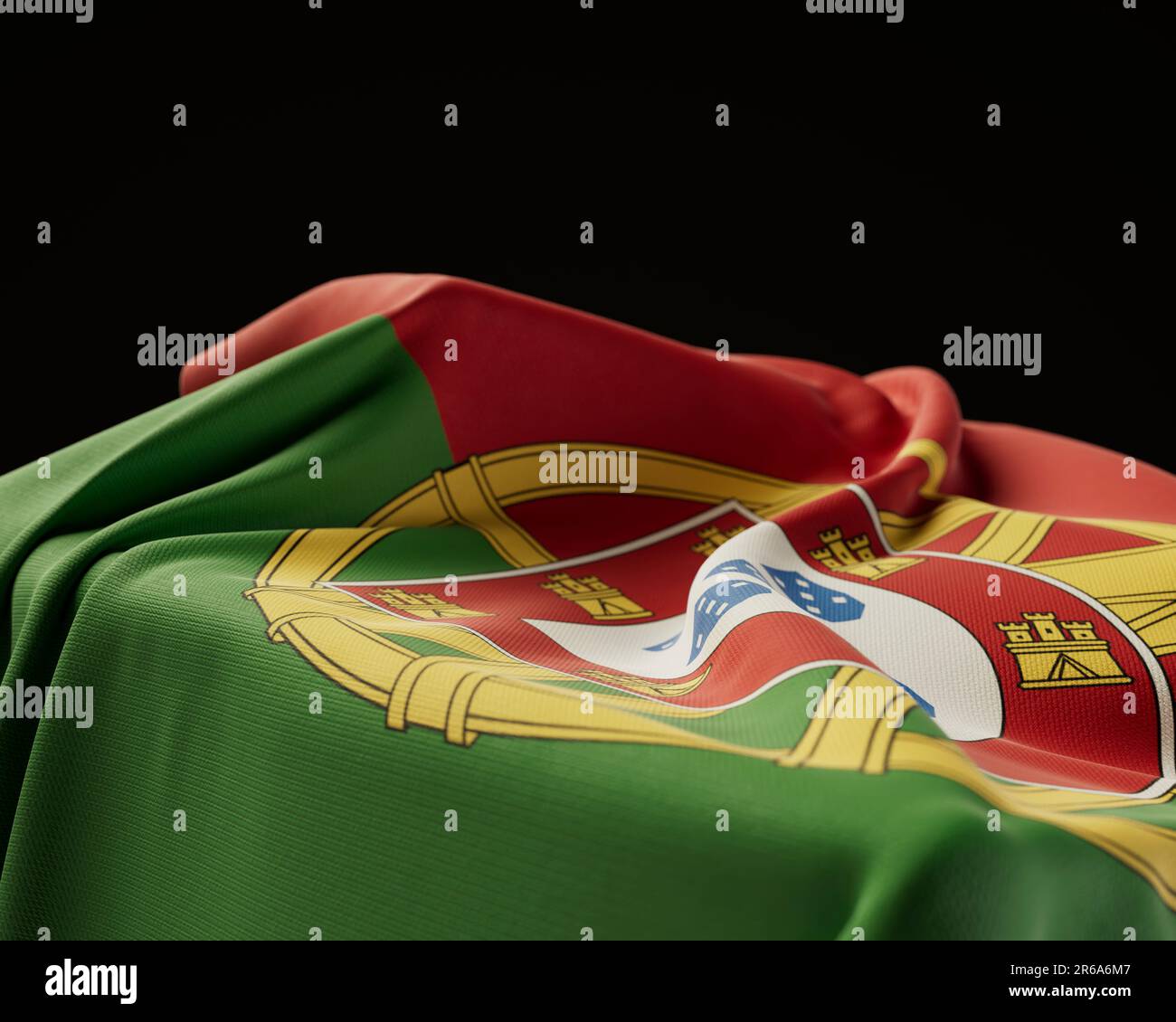 A portugal flag draped over a stone plinth on an isolated dark studio ...
