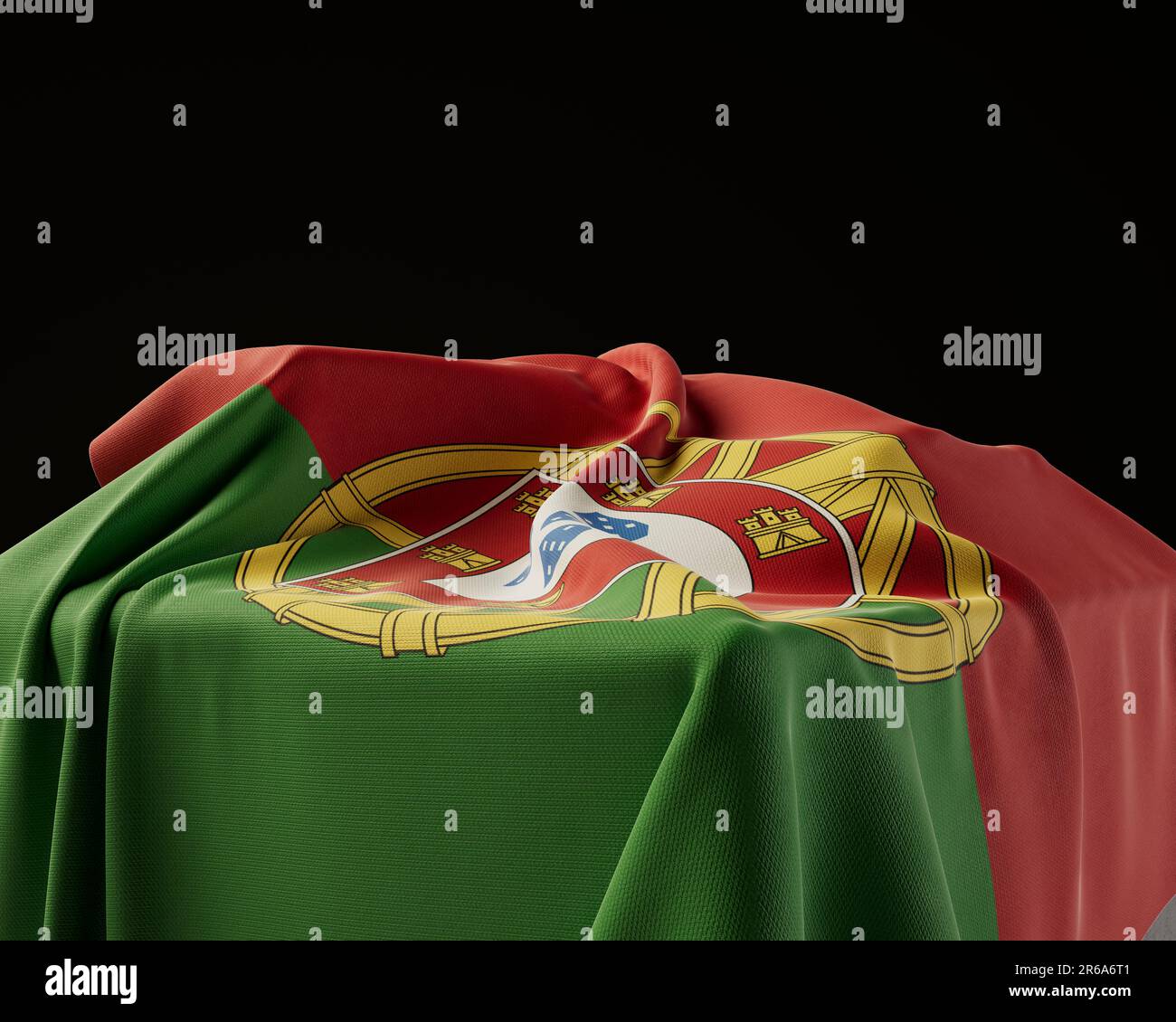 A portugal flag draped over a stone plinth on an isolated dark studio ...