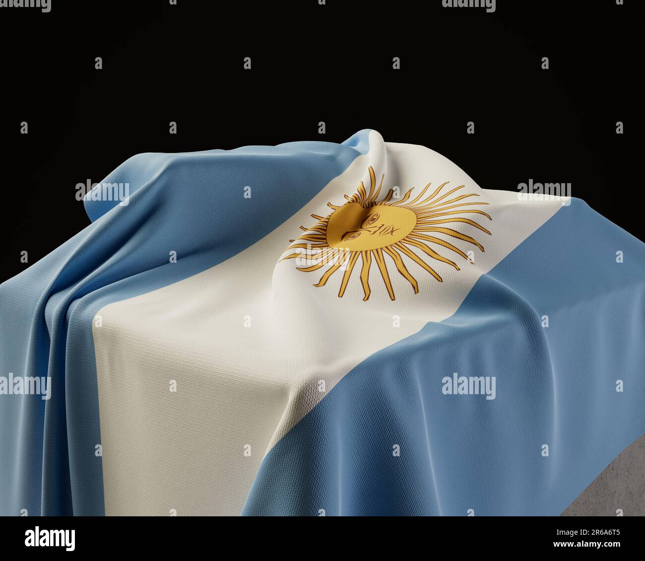 A argentina flag draped over a stone plinth on an isolated dark studio ...